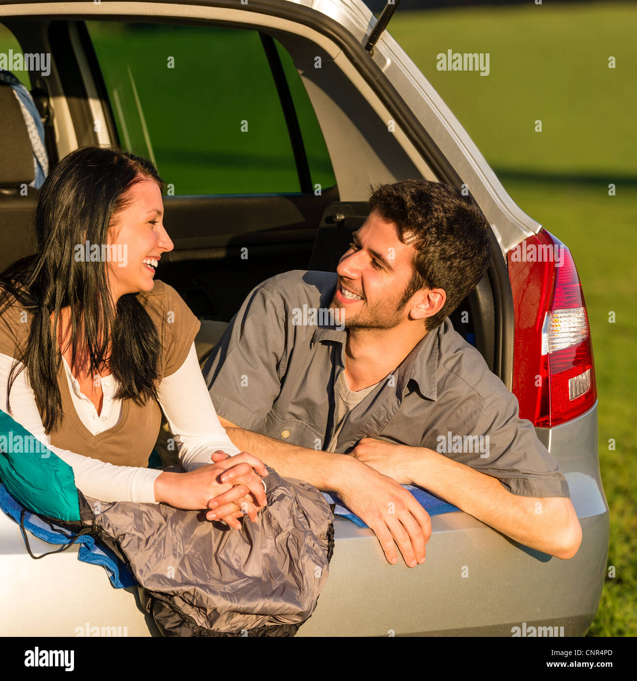 Camping young couple hugging together in car summer sunset Stock Photo ...