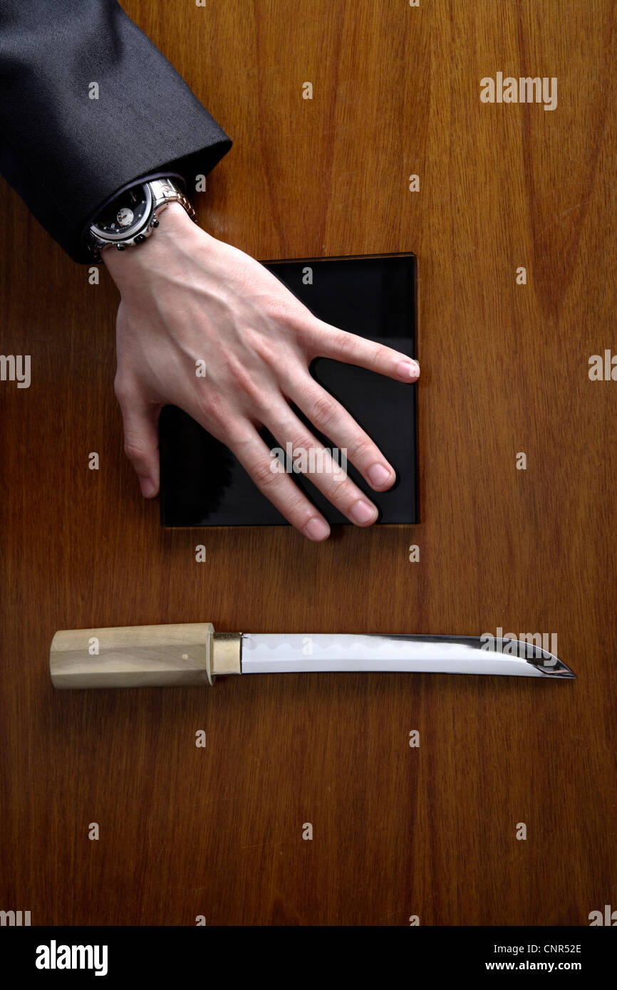 Man's Hand, Square Plate and Knife Stock Photo - Alamy