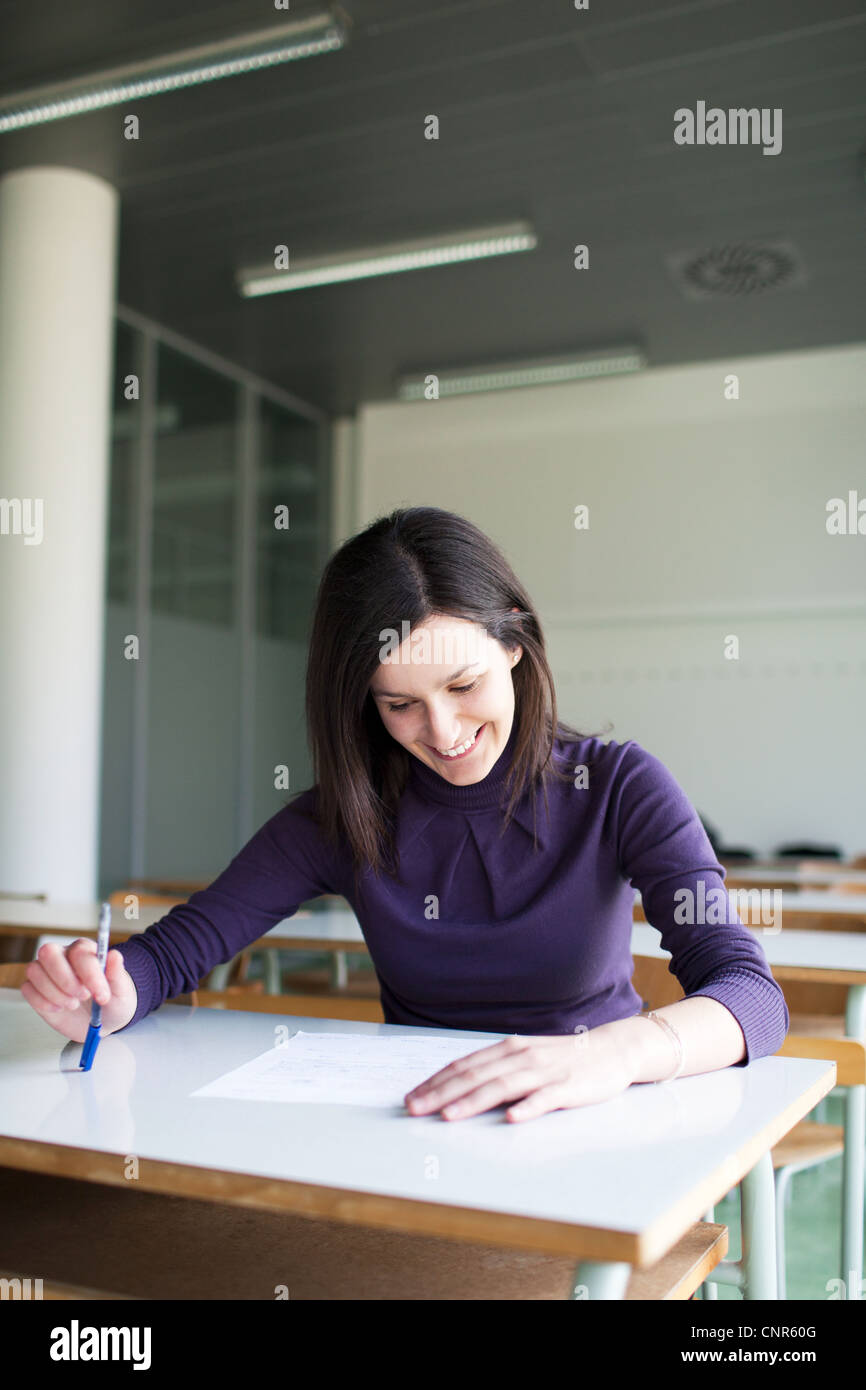 portrait of a pretty college student working in a classroom Stock Photo ...