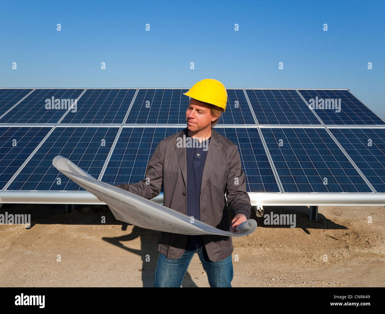 Architect with solar panels blueprints Stock Photo - Alamy