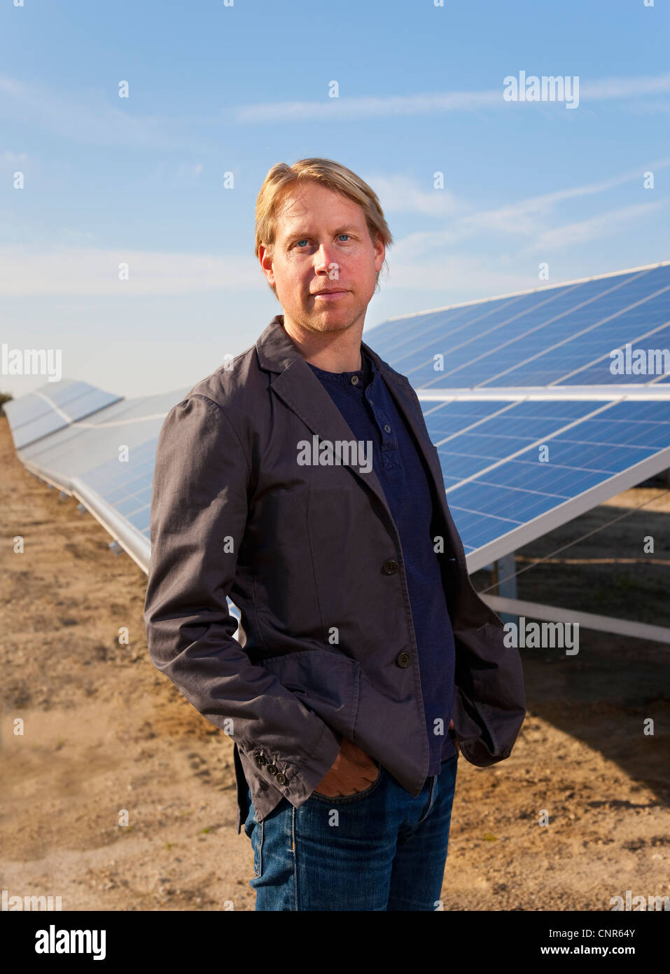 Architect in field with solar panels Stock Photo - Alamy