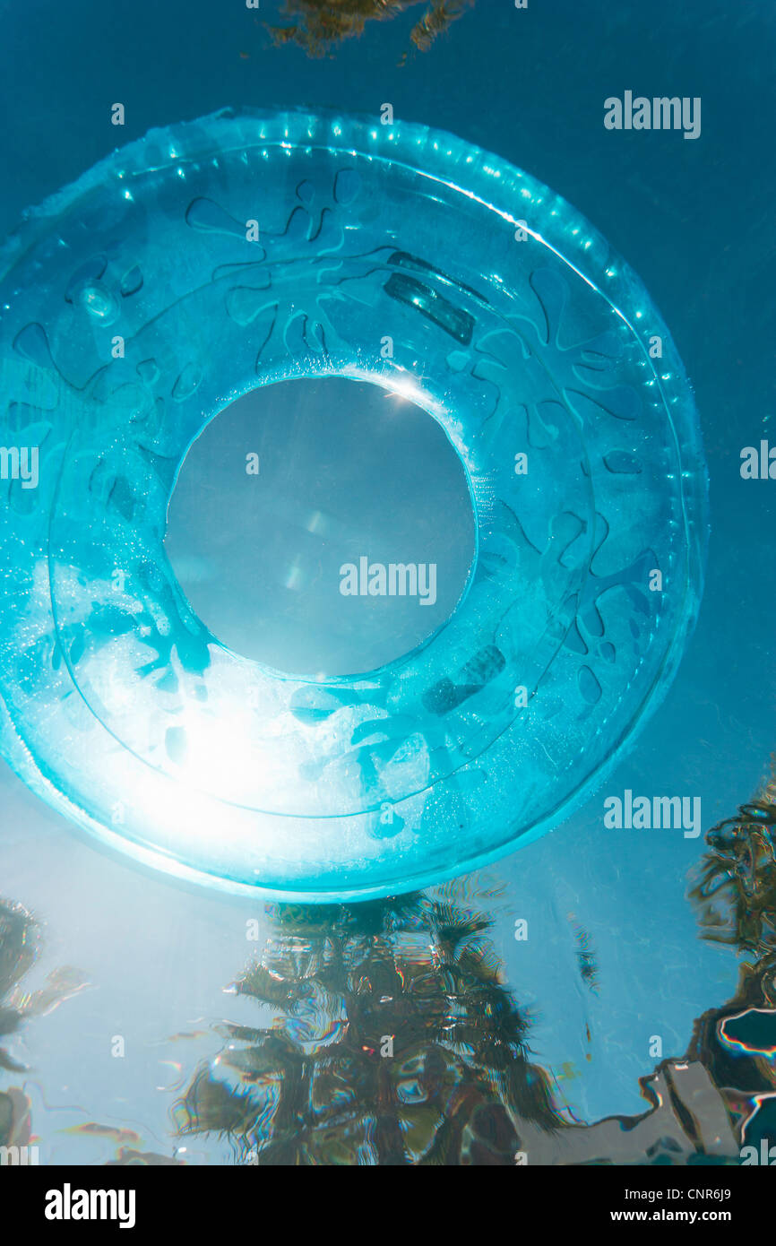 Inner tube floating in swimming pool Stock Photo - Alamy