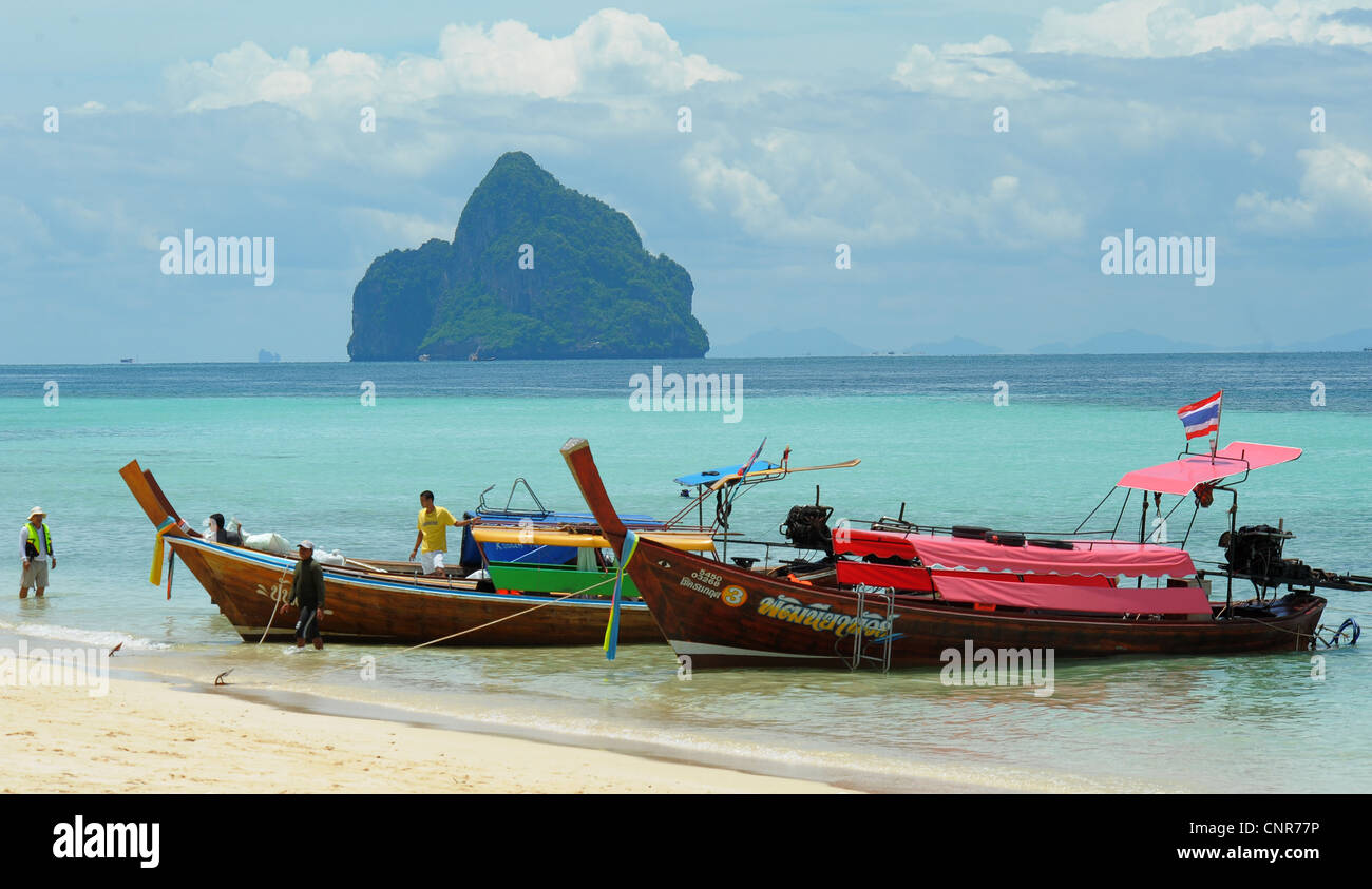 fishing boats moored on the beach of ao farang, the island of koh mook ...
