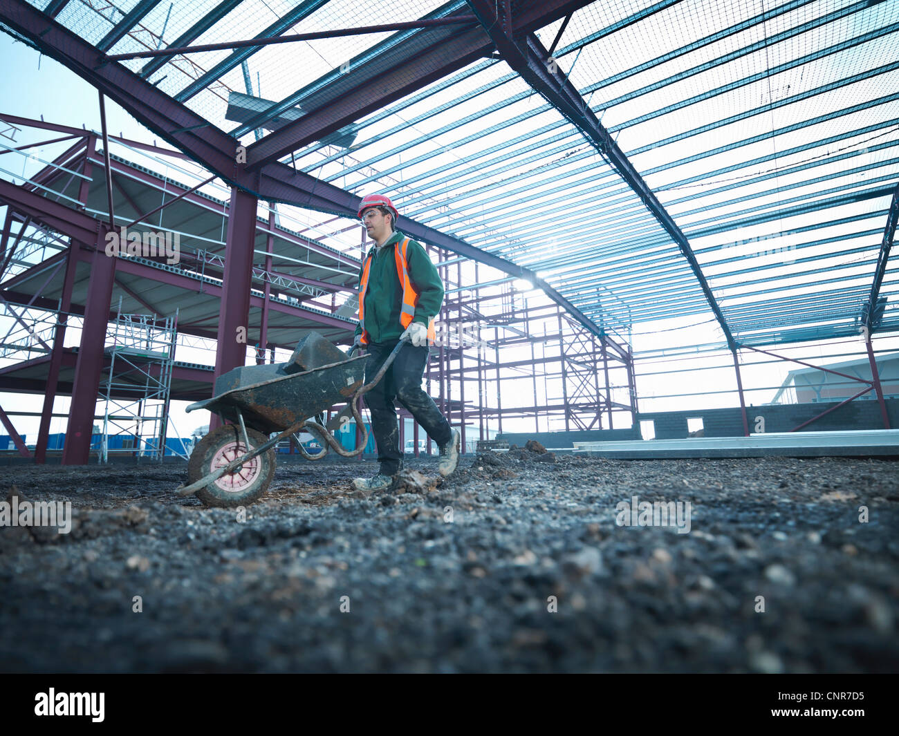 Worker Pushing Wheelbarrow High Resolution Stock Photography and Images ...