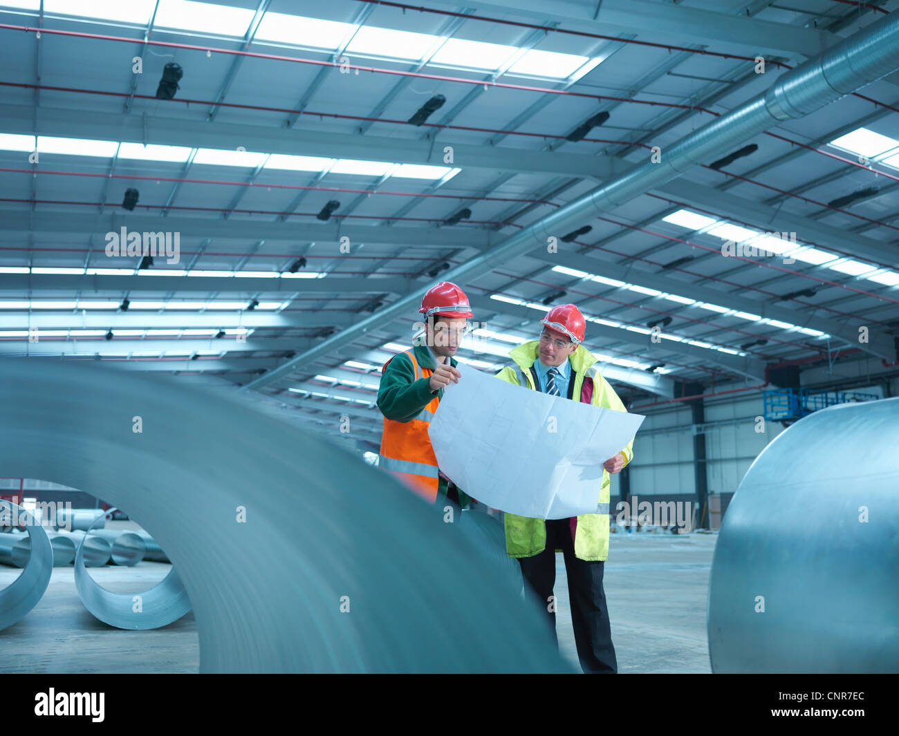 Construction workers looking blueprints on hi-res stock photography and ...