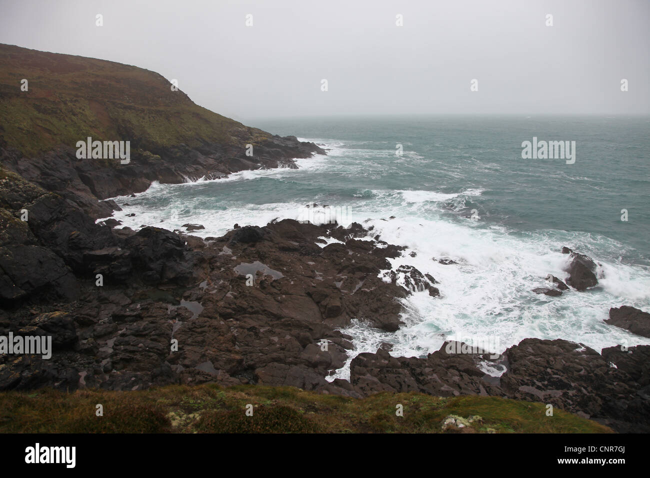The cliff and rocks at Treveal Cliff with a rough sea from the South ...