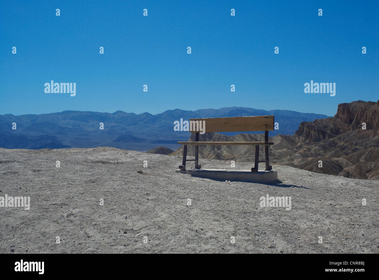 Bench on dirt path in mountains Stock Photo - Alamy