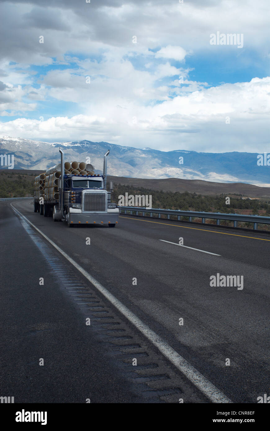 Truck carrying logs in rural landscape Stock Photo - Alamy