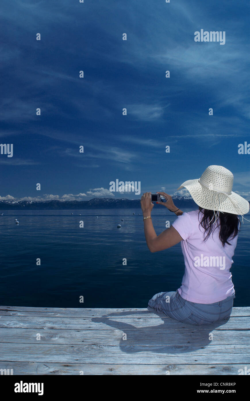 Woman taking pictures of still lake Stock Photo - Alamy