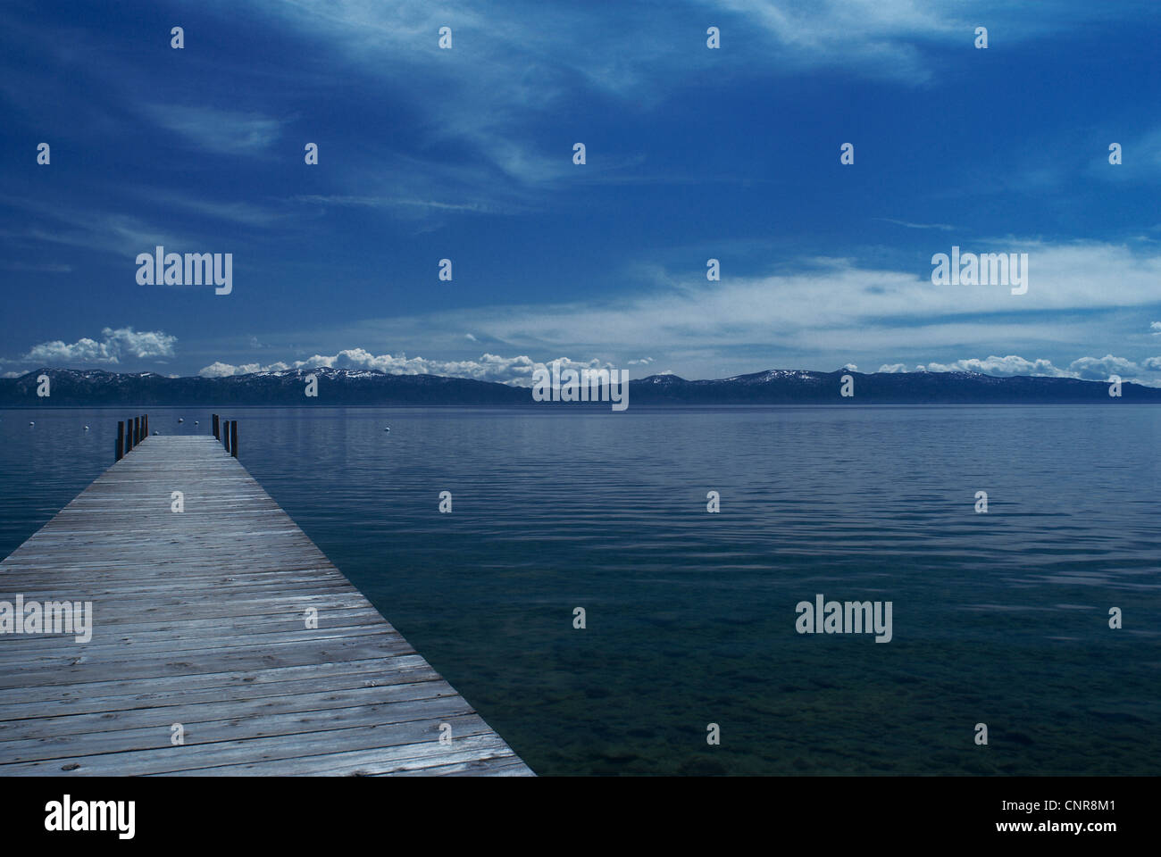 Wooden dock in still lake Stock Photo - Alamy