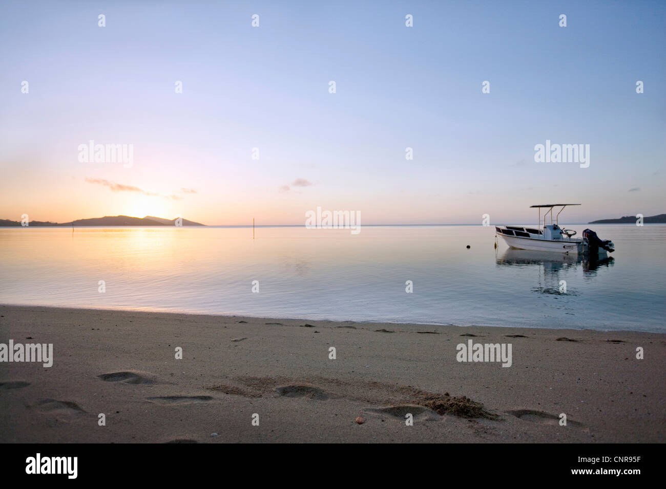 Boat in still ocean Stock Photo - Alamy