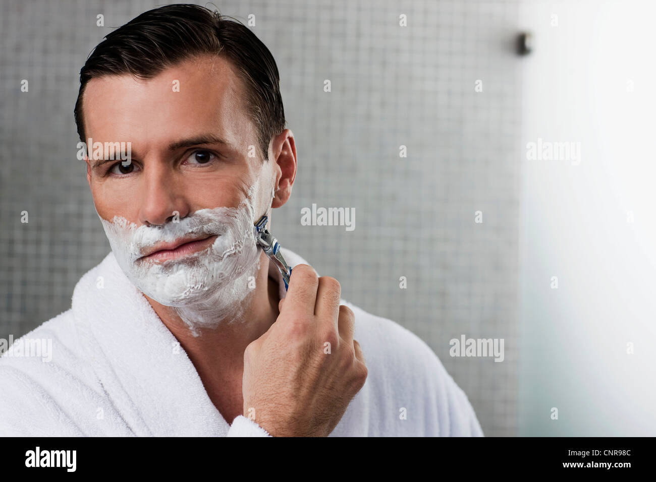 Man shaving in bathroom Stock Photo - Alamy