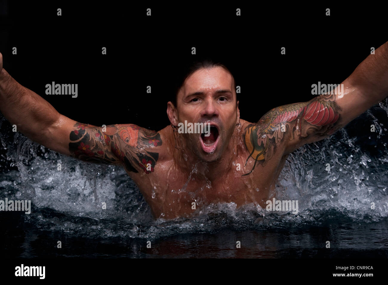 Man splashing in swimming pool Stock Photo - Alamy