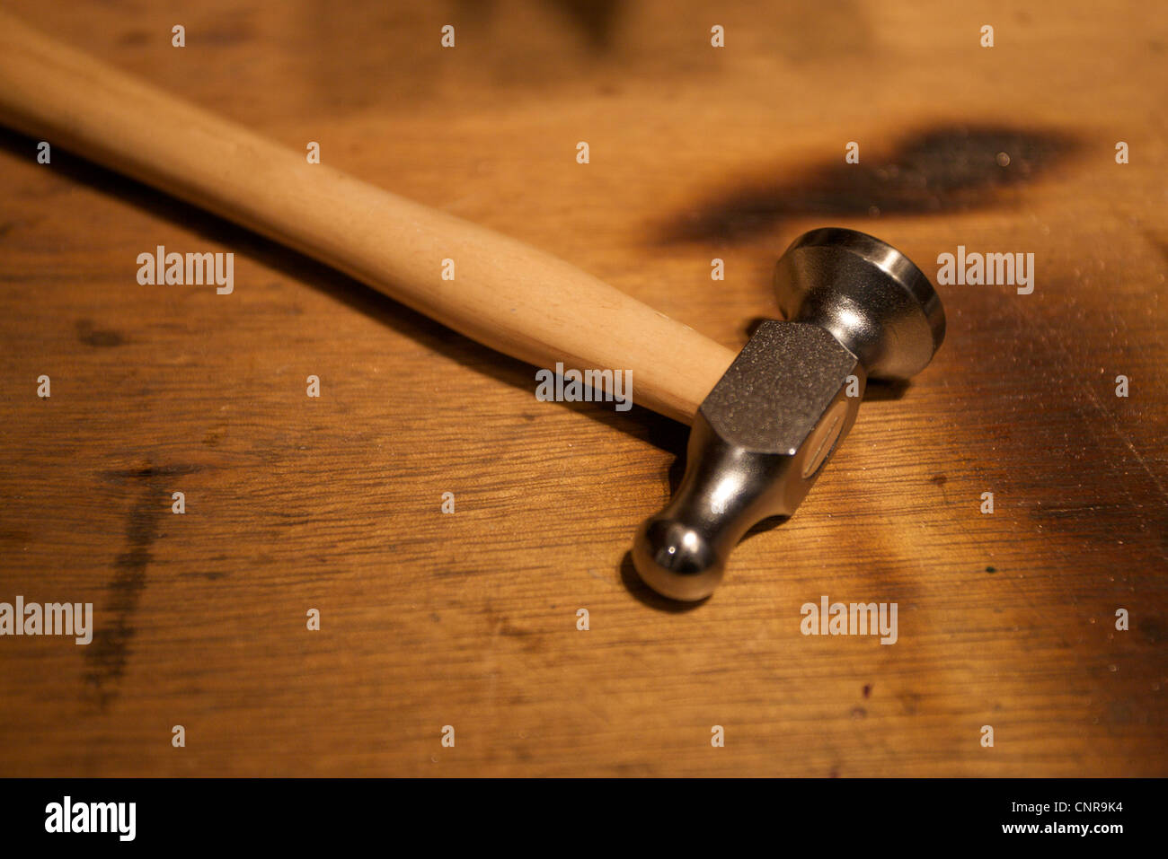 Metalsmiths hammer laying on workbench Stock Photo - Alamy