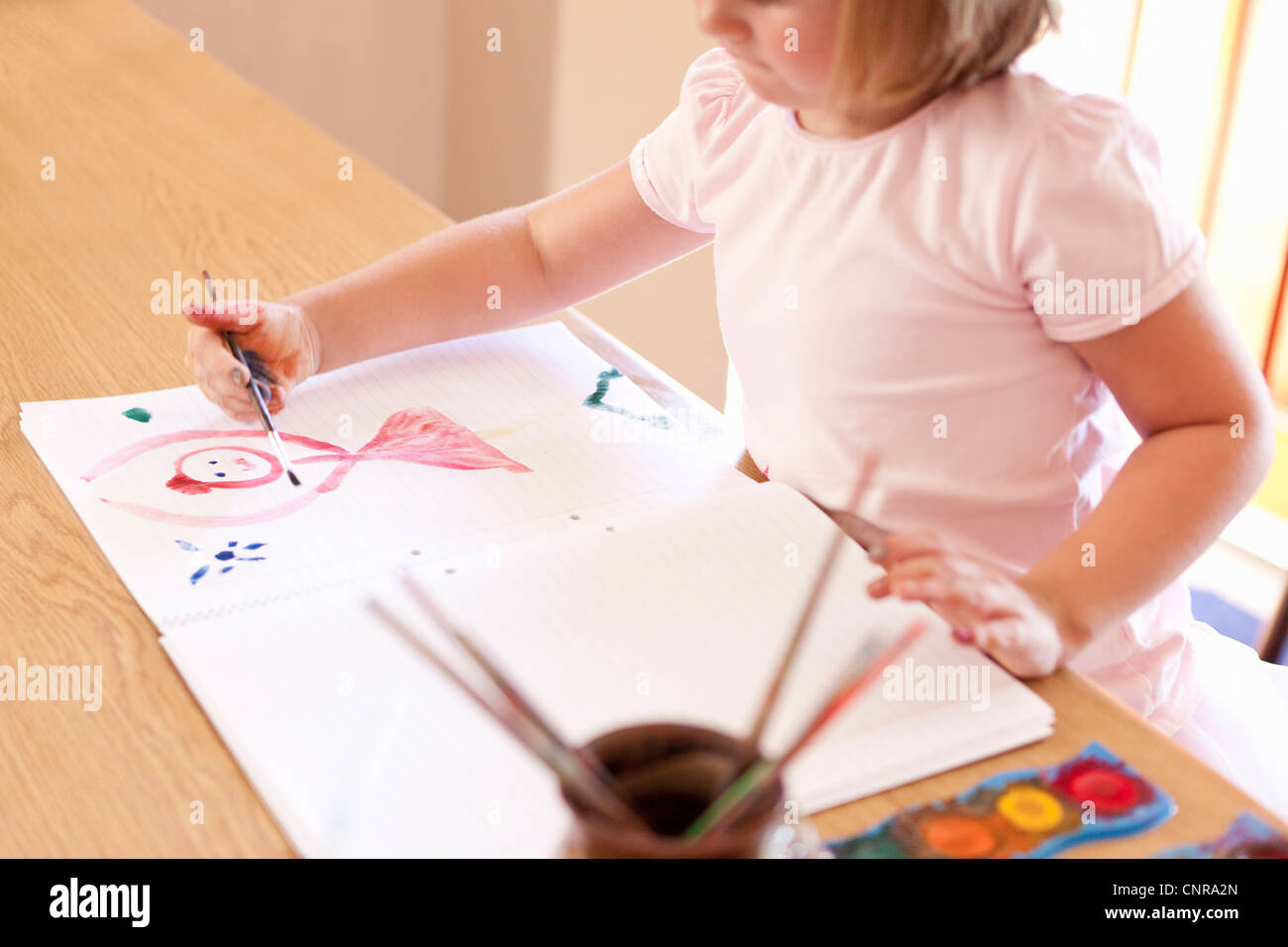 Girl painting with watercolors Stock Photo - Alamy