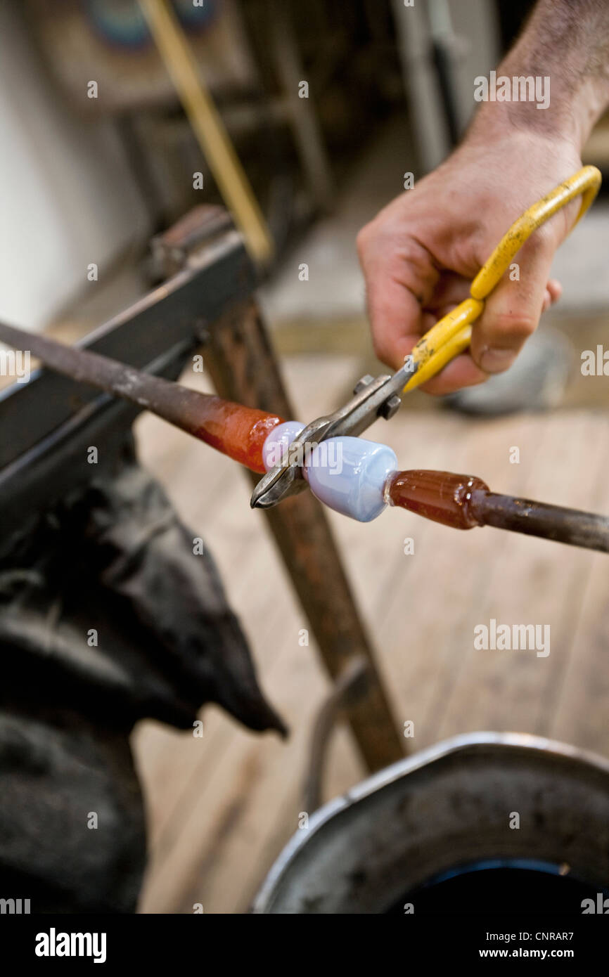 Glassblower snipping hot glass Stock Photo - Alamy