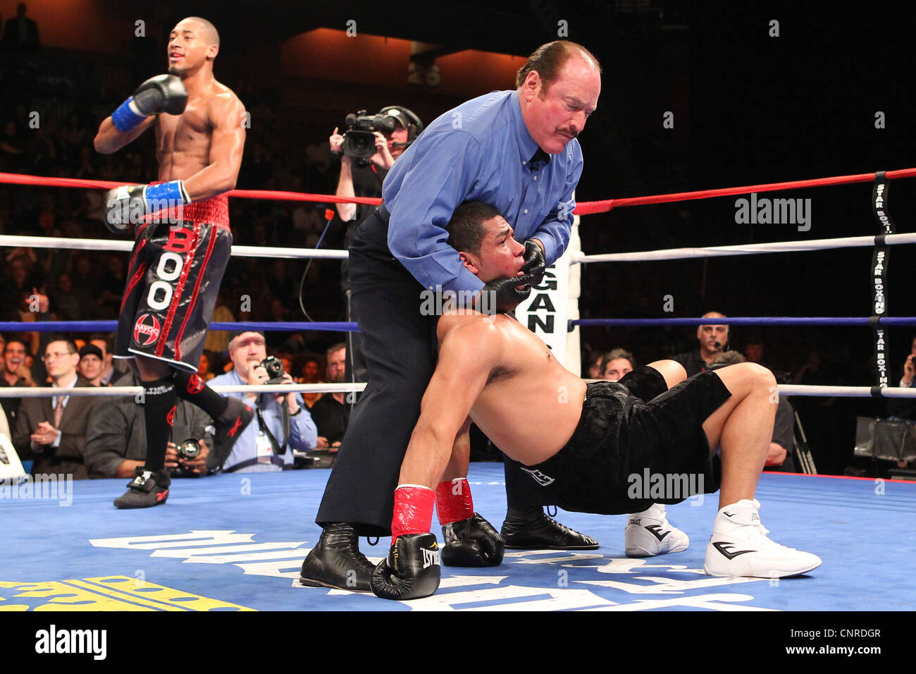 Demetrius Andrade (Black Red trunks) celebrates as referee Steve Smoger ...