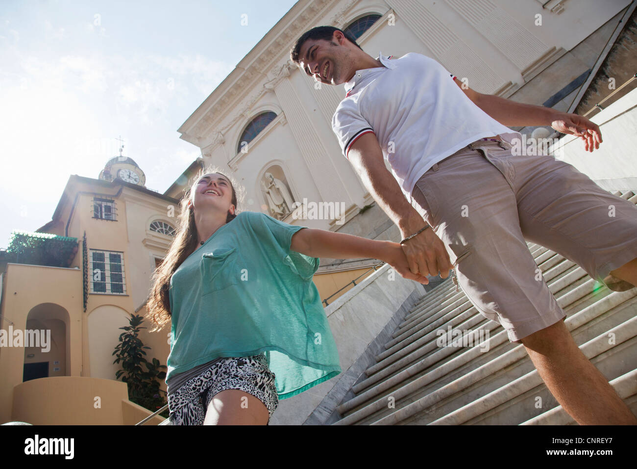 Couple climbing steps of ornate building Stock Photo - Alamy