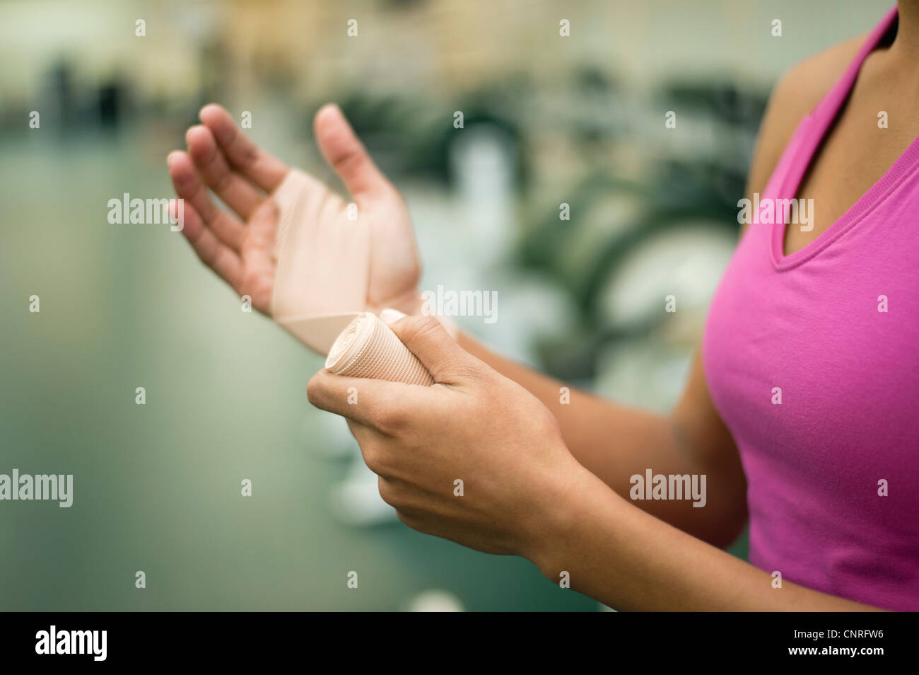 Woman wrapping hand with bandage, cropped Stock Photo - Alamy