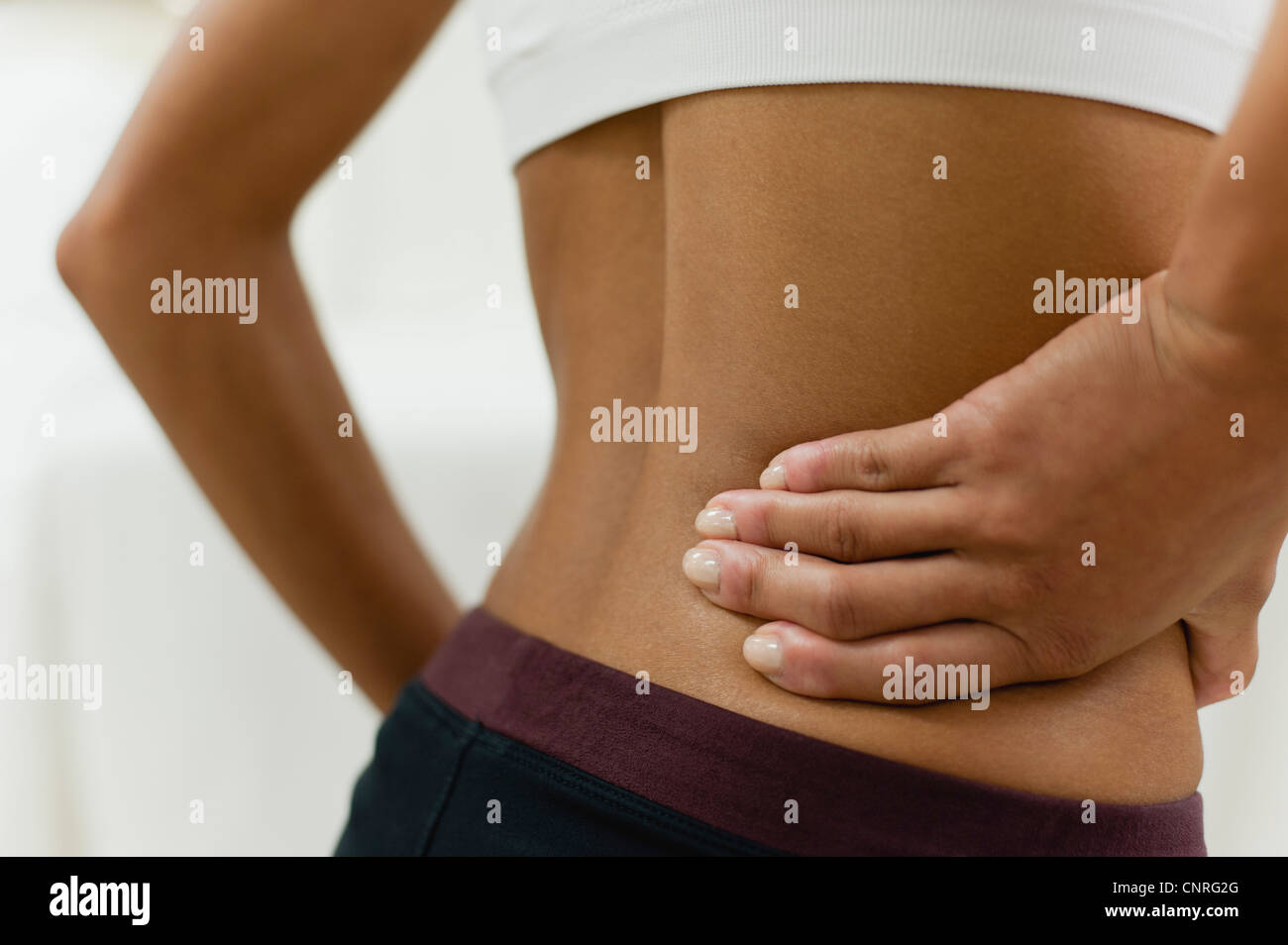 Hand on lower back hi-res stock photography and images - Alamy