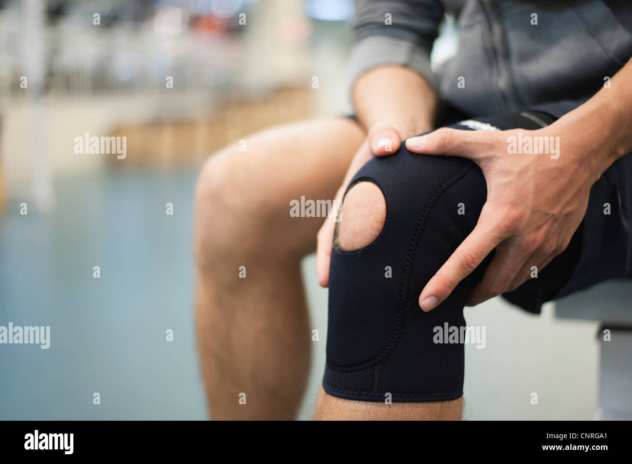 Man wearing knee brace, cropped Stock Photo - Alamy