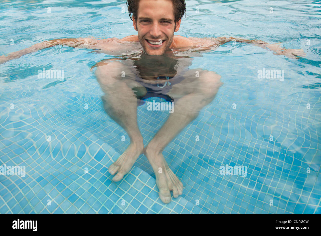 Young man in swimming pool Stock Photo - Alamy