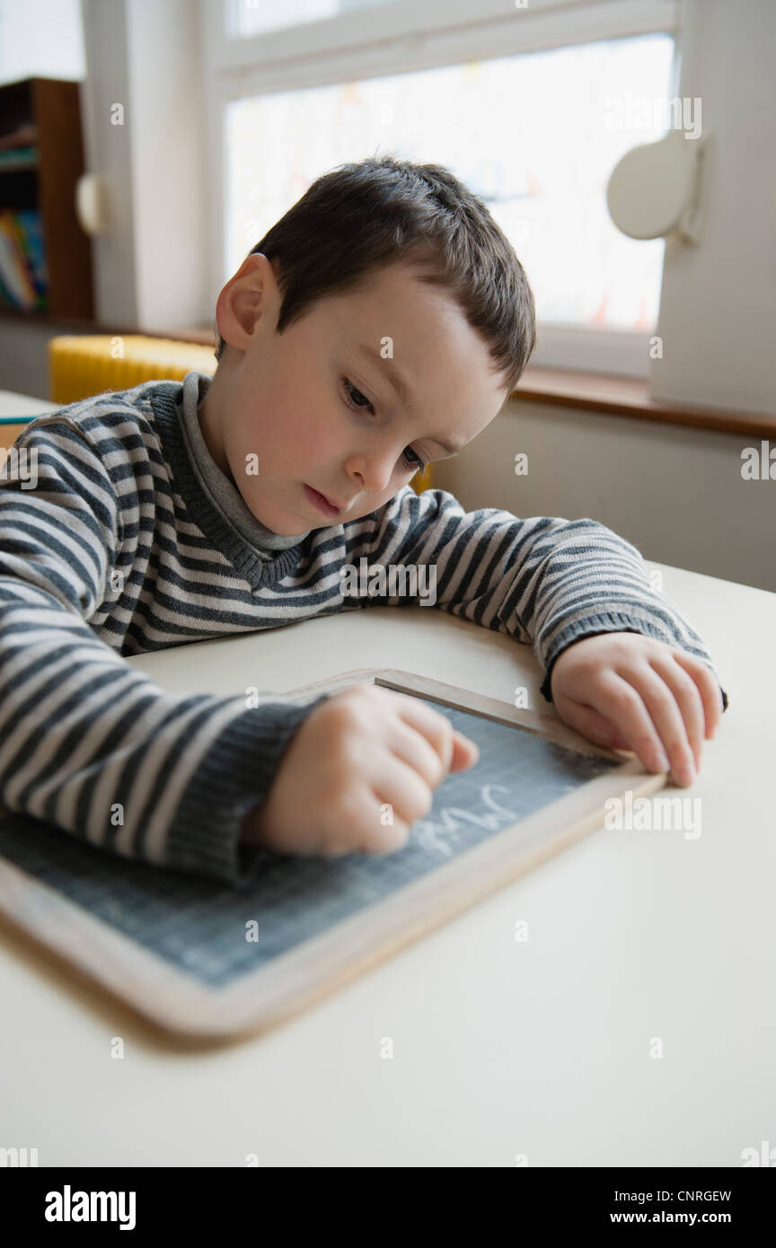 Elementary students writing drawing desks hi-res stock photography and ...
