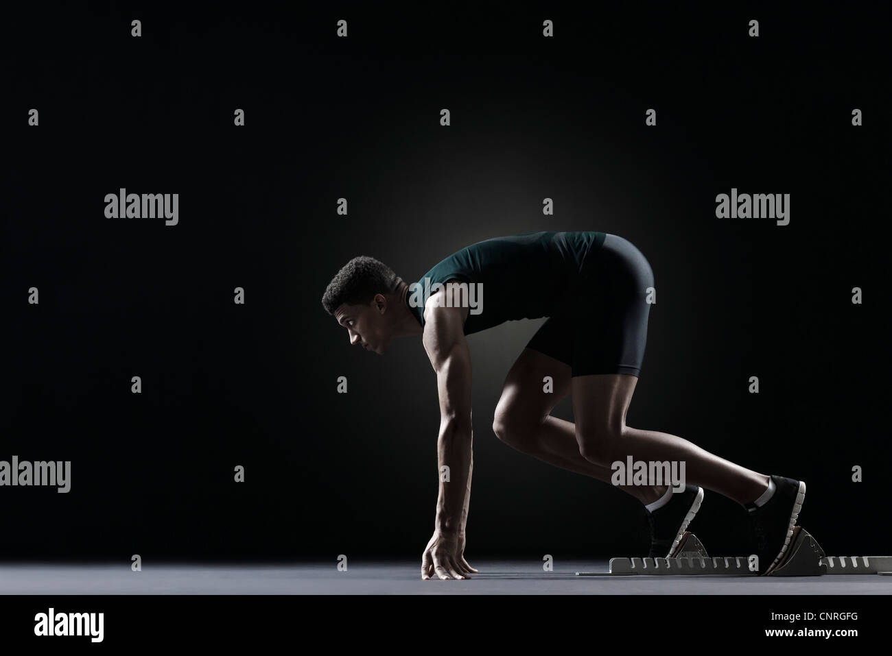 Runner on starting block Stock Photo - Alamy