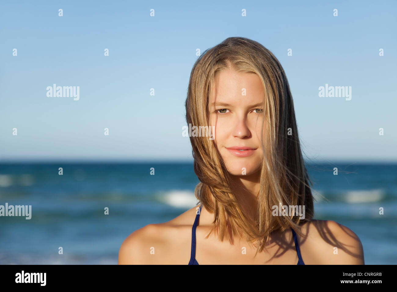 Young woman by ocean, portrait Stock Photo - Alamy