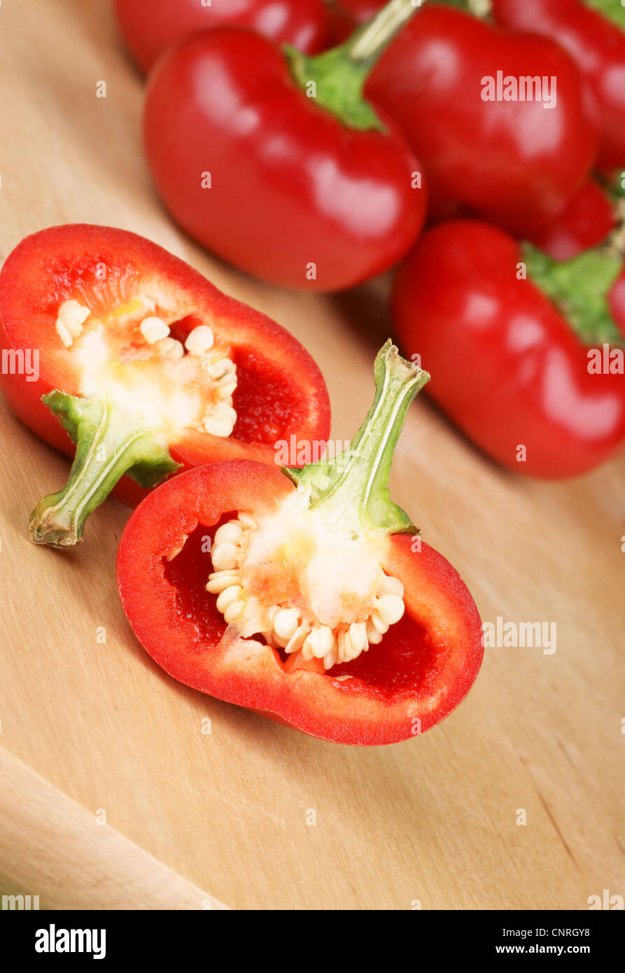 Sliced, round, red chili pepper over a wooden cutting board Stock Photo ...