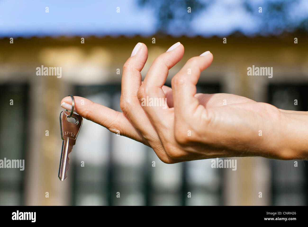 Woman's hand holding key, cropped Stock Photo - Alamy