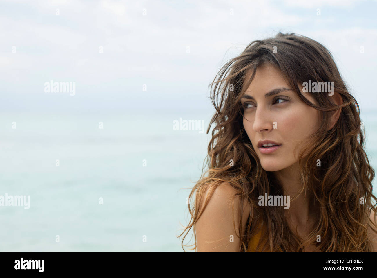 Young woman looking over shoulder, portrait Stock Photo - Alamy