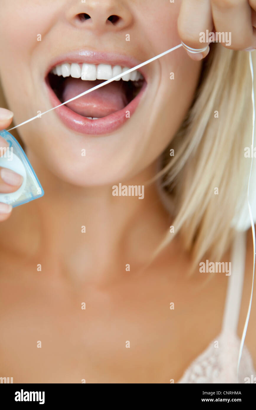 Woman using dental floss, cropped Stock Photo - Alamy