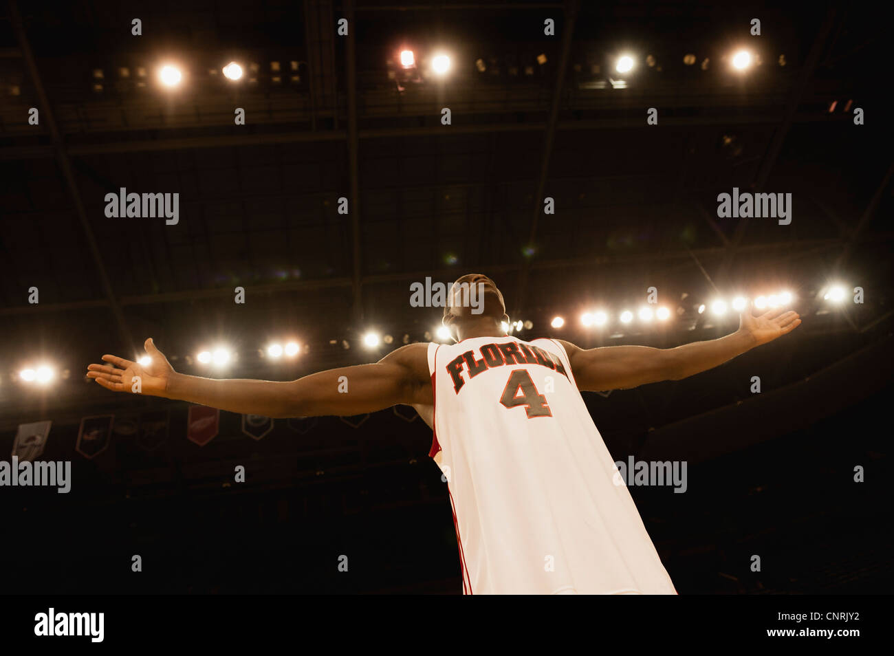 Basketball player standing with arms out, low angle view Stock Photo ...