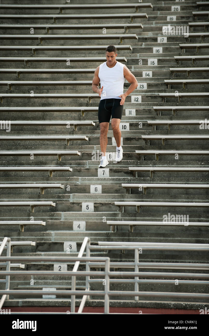 Male athlete running down stadium steps Stock Photo - Alamy