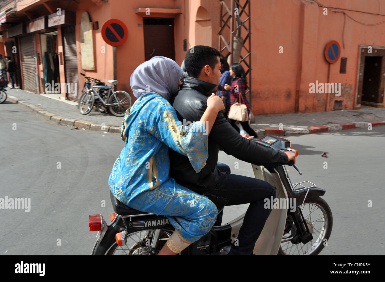 Young Muslim couple speed past on a motorbike, Marrakesh, Morocco Stock ...