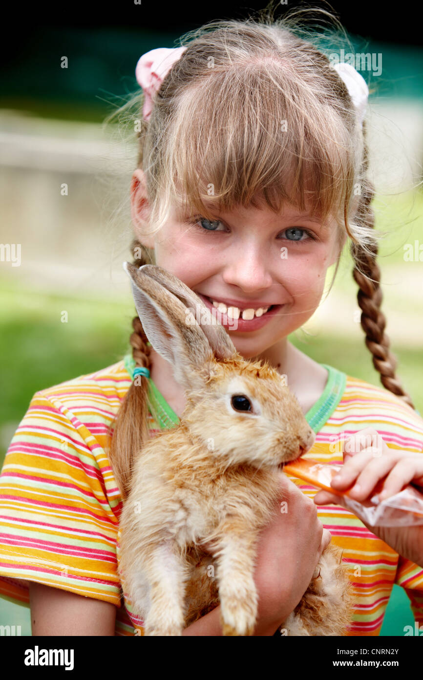 Child with rabbit on summer outdoor Stock Photo - Alamy
