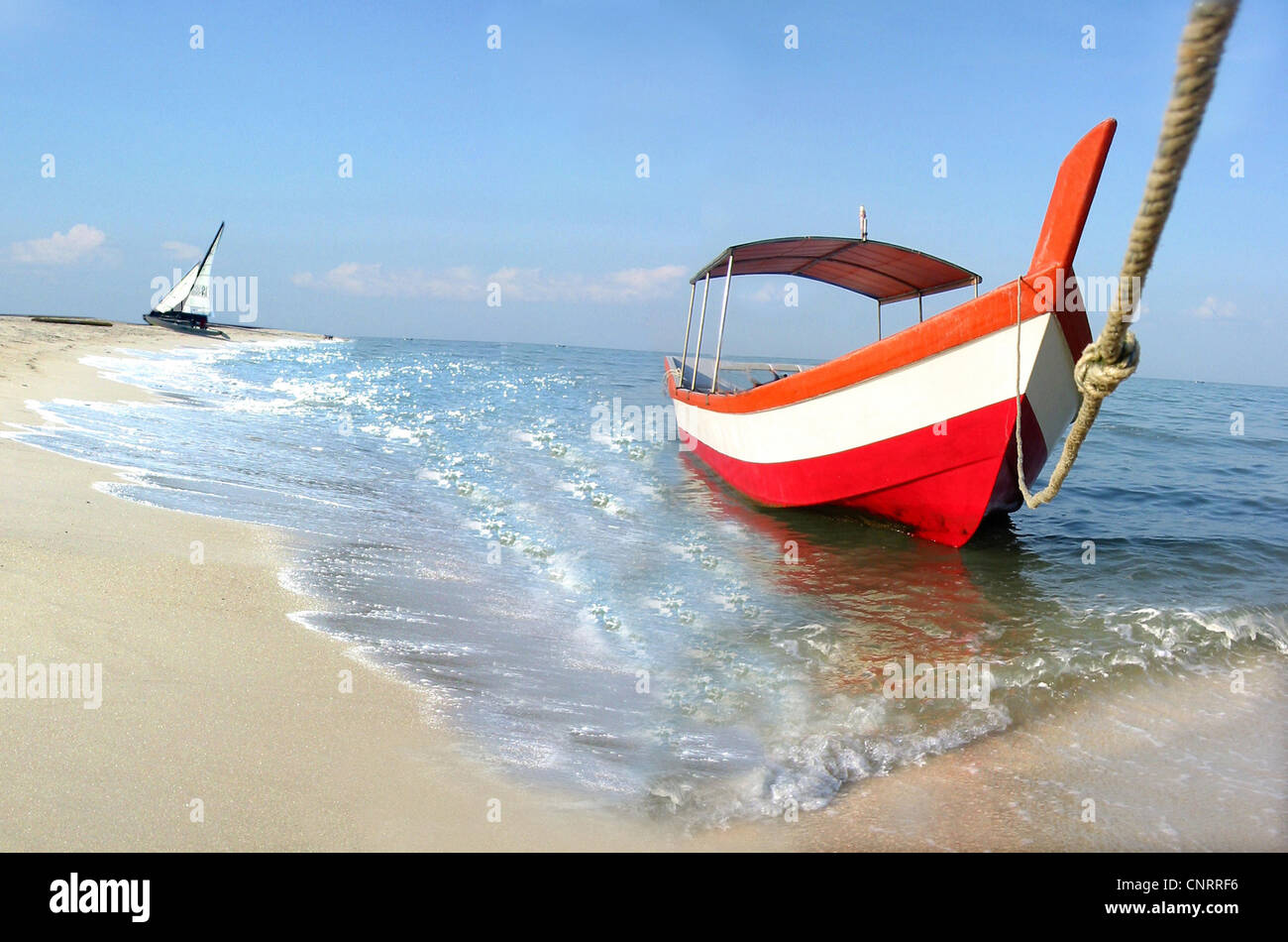 boat and sailing ship at the beach Stock Photo - Alamy