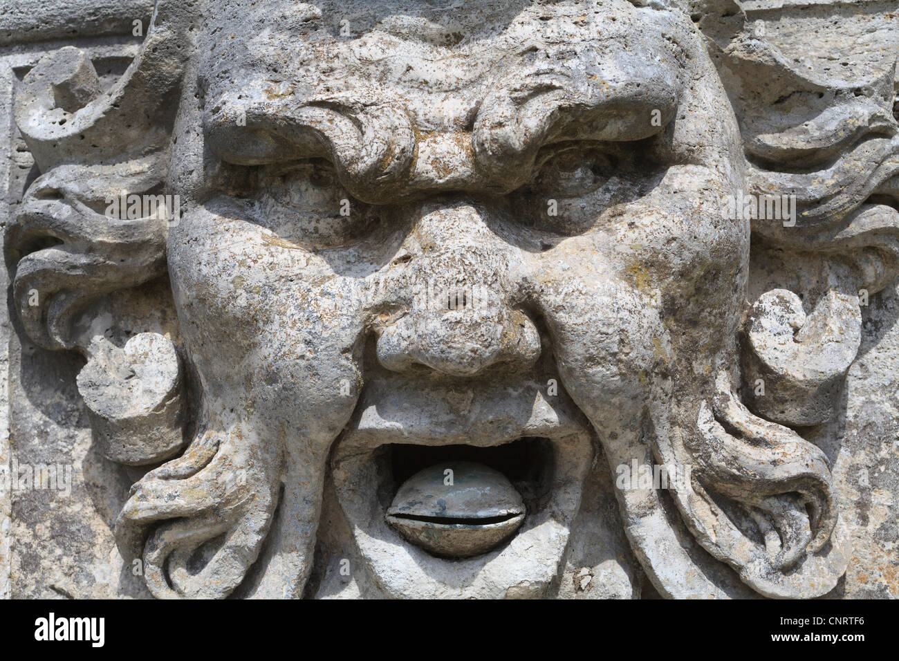 Stone carving of face with water spout Stock Photo - Alamy