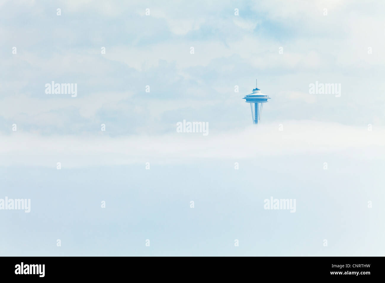 A fog bank obscures downtown Seattle and the Space Needle sticks up ...