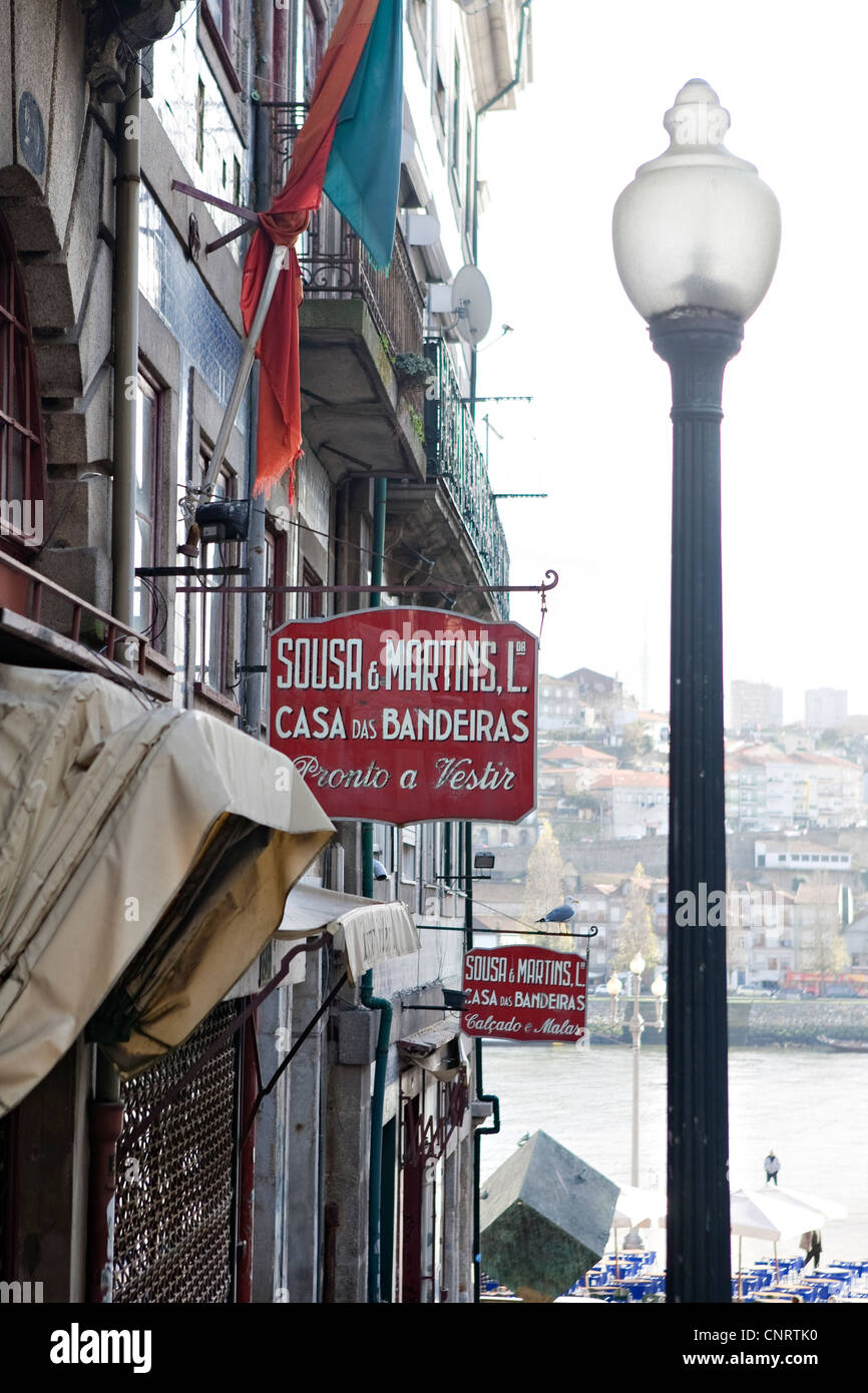 Shop signs on street near Ribeira Quay, Oporto, Portugal Stock Photo ...
