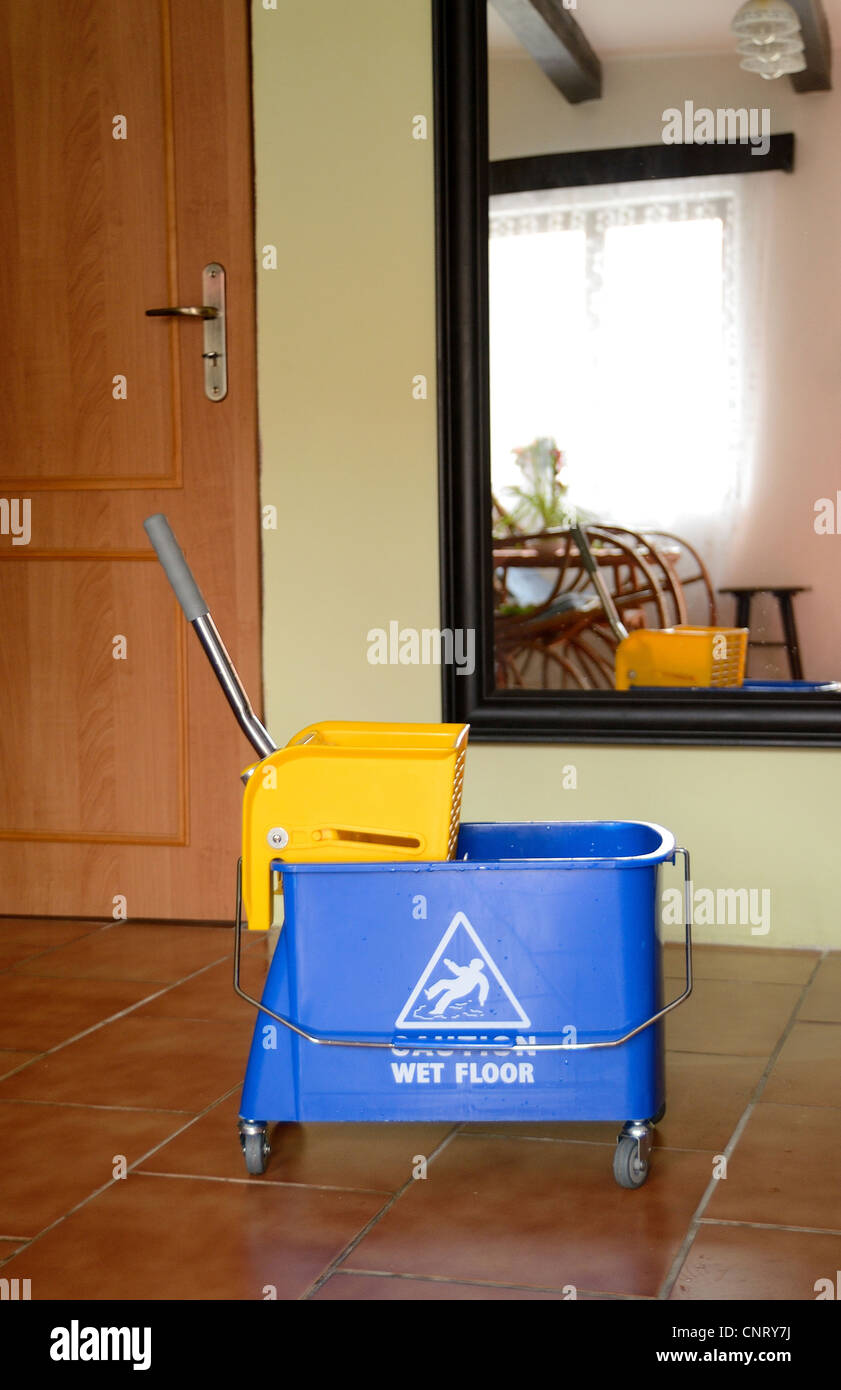 Blue cleaning cart with warning notice Stock Photo - Alamy