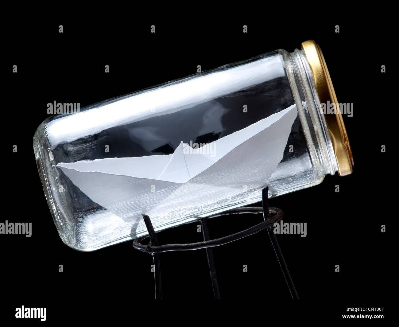 Paper ship in the jar on a black background Stock Photo - Alamy