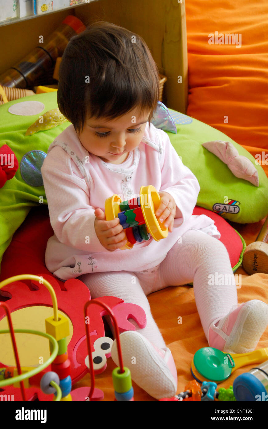 TODDLER IN PLAYGROUND EXPLORING THE TOY Stock Photo - Alamy