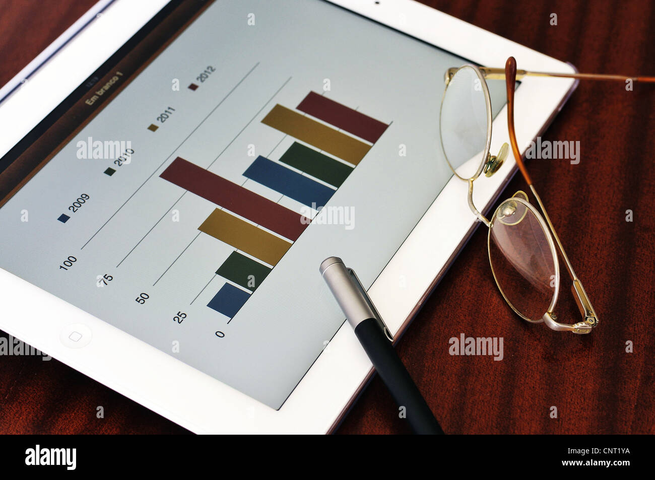 Bar chart in tablet with pen and glasses Stock Photo - Alamy