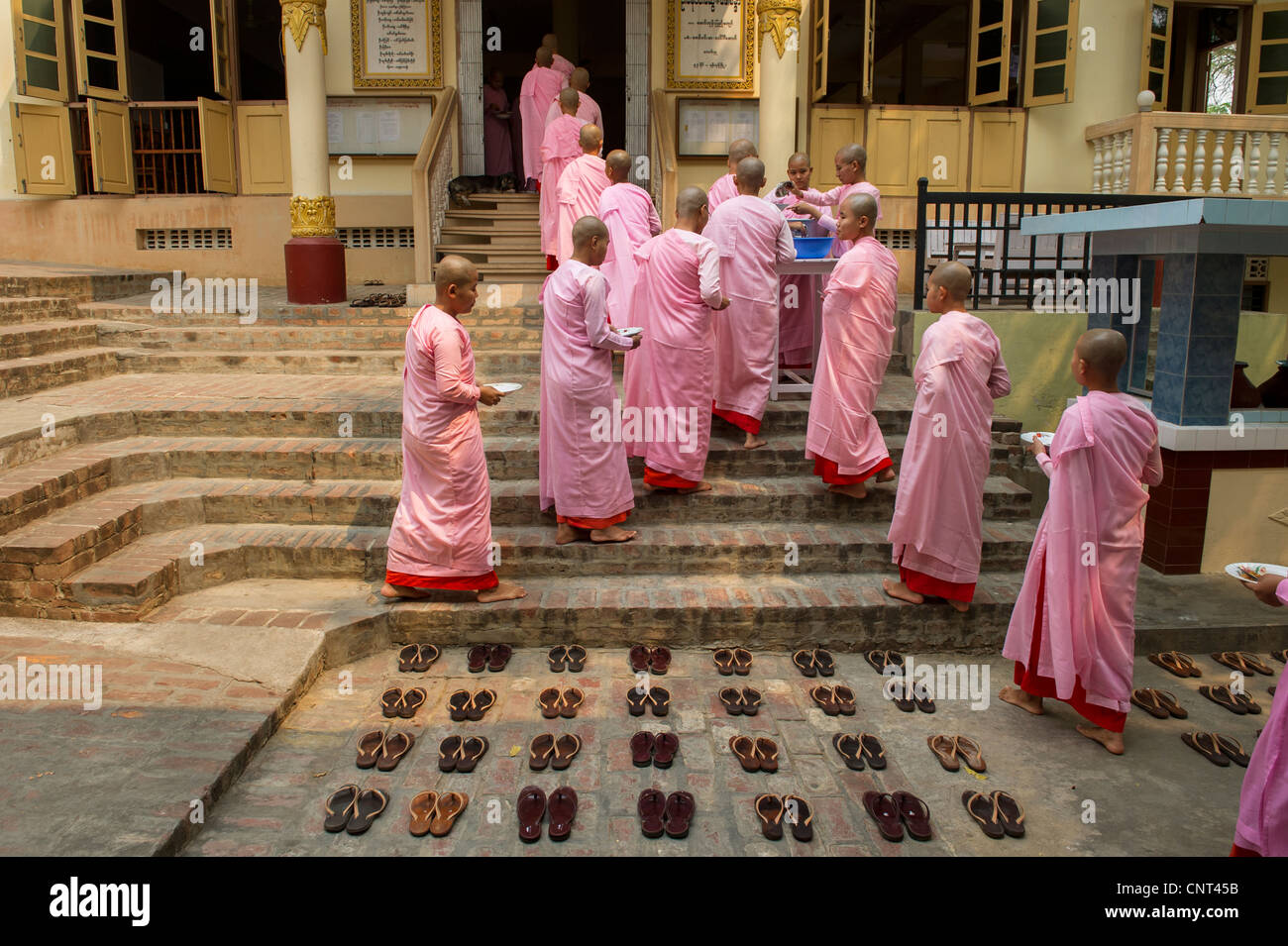 Buddhist nuns entering the dining hall at the Sakyadhita Thilashin ...