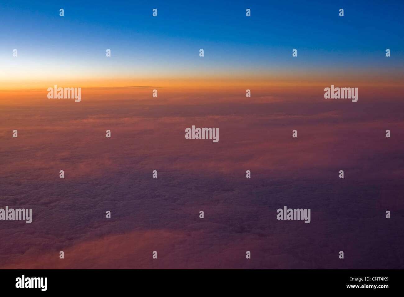 sunset over clouds Stock Photo - Alamy