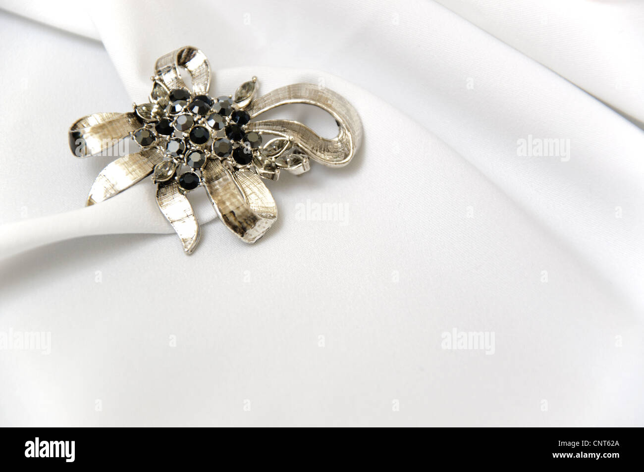 White satin and brooch Stock Photo - Alamy