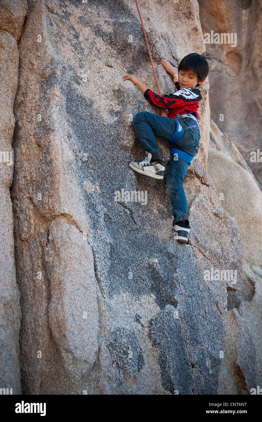 young boy rock climb climbing wall risk sport extreme outdoor nature ...