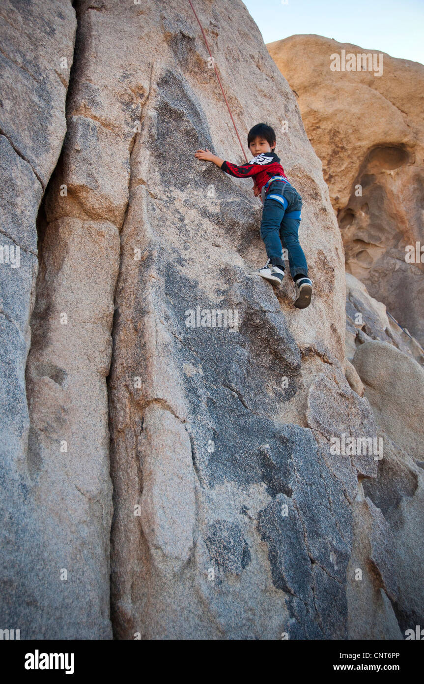 young boy rock climb climbing wall risk sport extreme outdoor nature ...